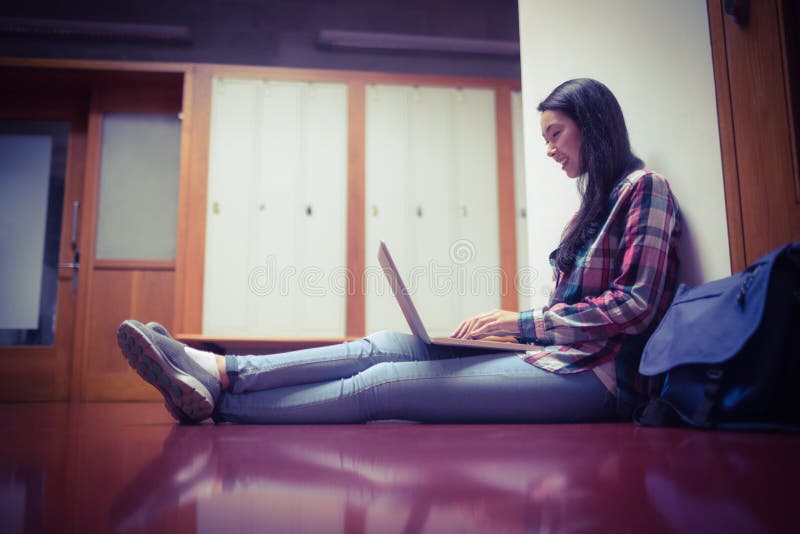Smiling Student Sitting on the Floor and Using Laptop Stock Image ...