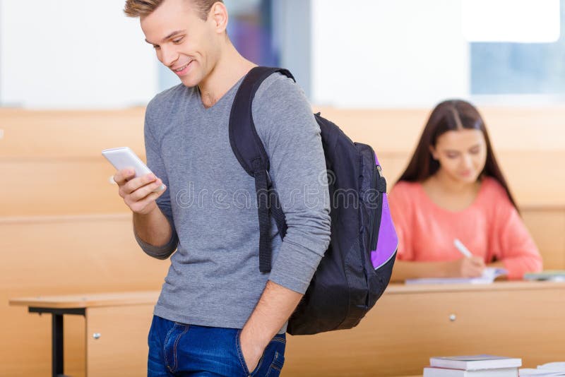 Smiling Student is Texting on the Phone Stock Image - Image of handsome ...