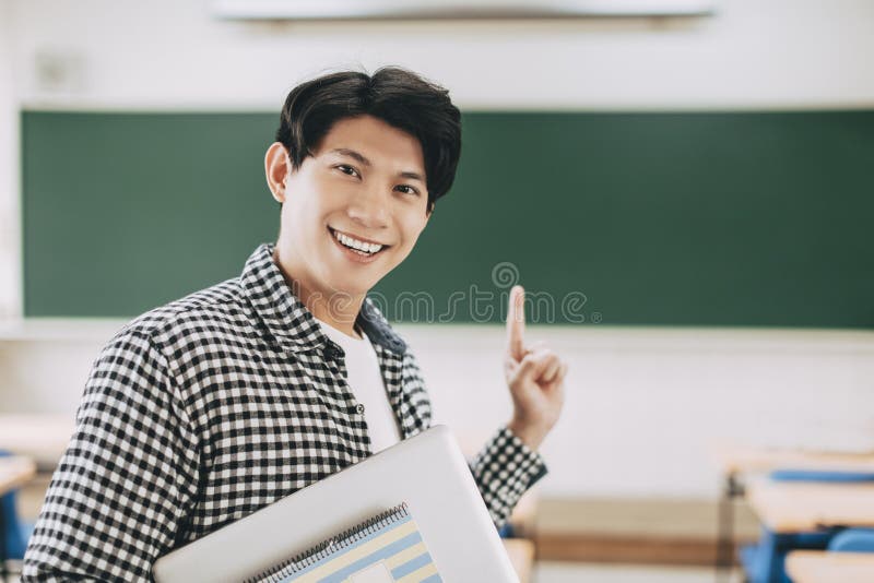 Smiling Student in University Classroom Hand Pointing Stock Photo ...