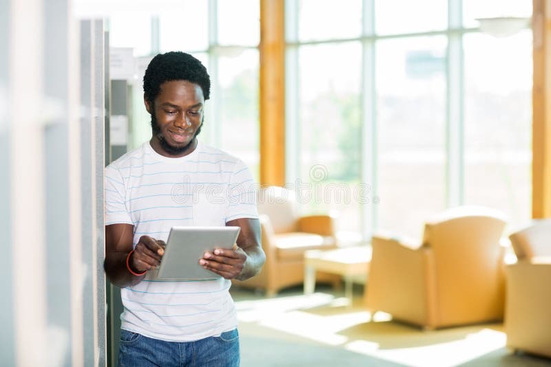 Smiling Student Using Digital Tablet at Library Stock Image - Image of ...