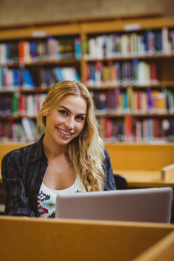 Smiling Student Working while Using Her Laptop Stock Photo - Image of ...