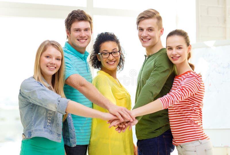 Smiling Students with Hands on Top of Each Other Stock Photo - Image of ...