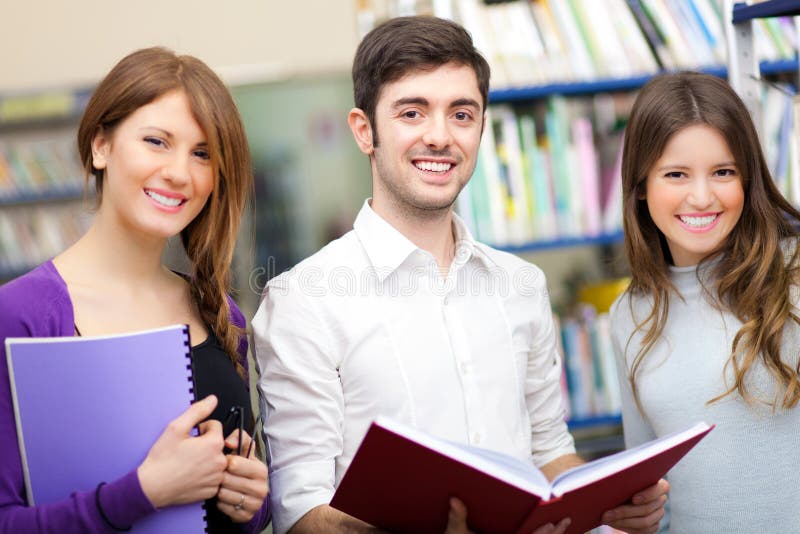 Smiling Students in a Library Stock Image - Image of library, reading ...