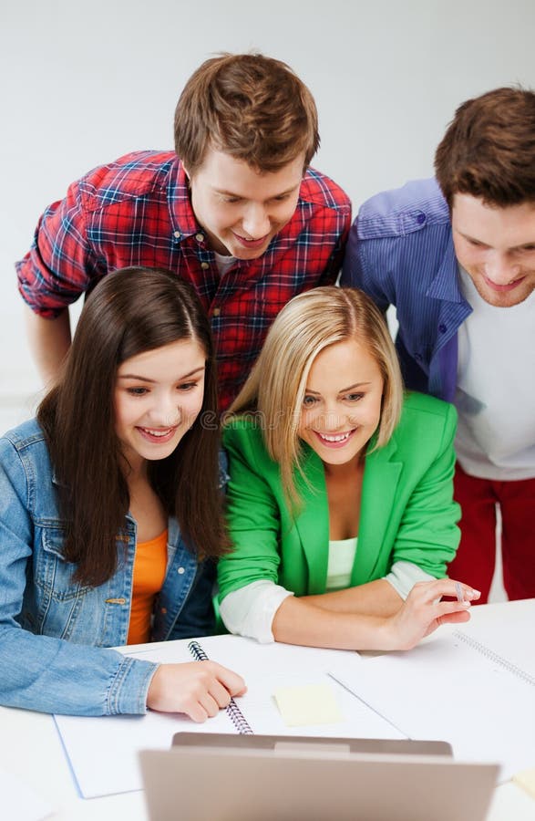 Smiling Students Looking at Laptop at School Stock Image - Image of ...