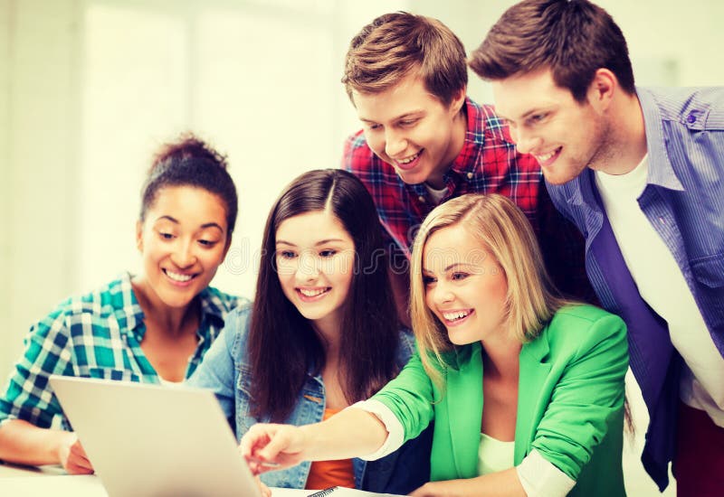 Smiling Students Looking at Laptop at School Stock Photo - Image of ...