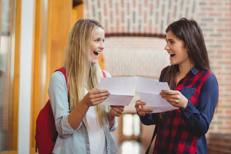 Smiling Students Looking at Results Stock Image - Image of book ...