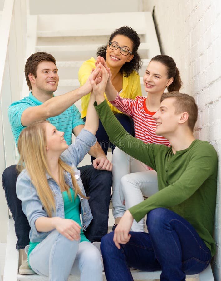 Smiling Students Making High Five Gesture Sitting Stock Photo - Image ...