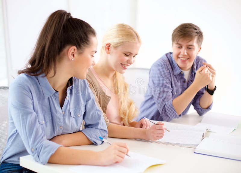 Two Teenagers with Notebooks and Book at School Stock Photo - Image of ...