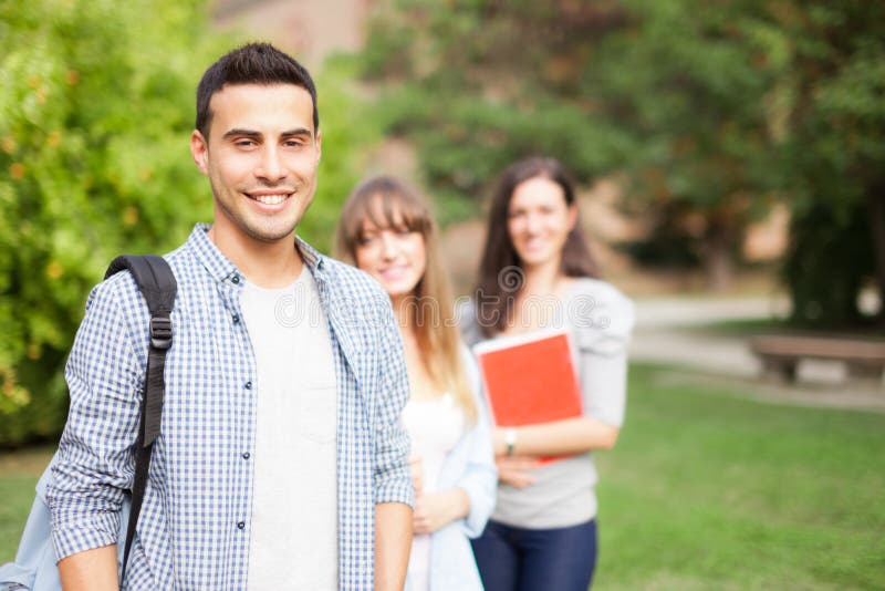 Smiling students in a park stock photo. Image of person - 50880028