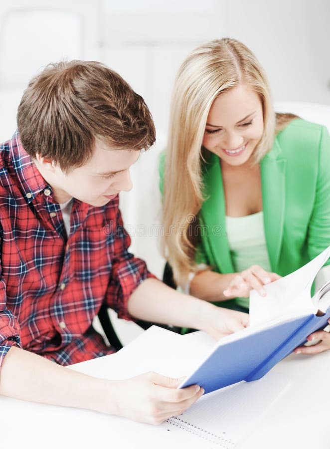 Smiling Students Reading Book at School Stock Image - Image of ...