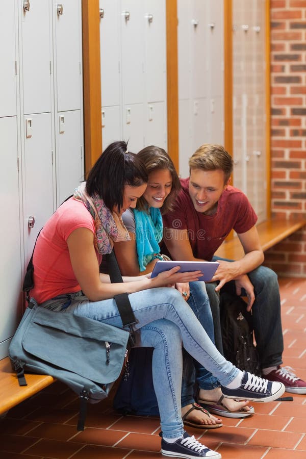 Smiling Students Sitting on Bench Using Tablet Stock Image - Image of ...