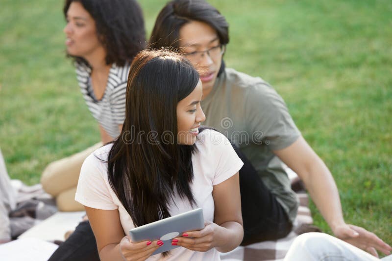 Smiling Students Studying Outdoors. Looking Aside Stock Photo - Image ...