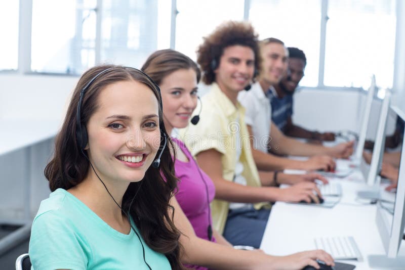 Smiling Students Using Headsets in Computer Class Stock Image - Image ...
