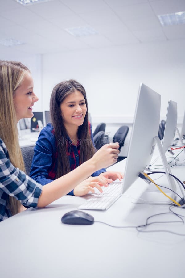 Two Students Working Together with Book and Laptop Stock Image - Image ...
