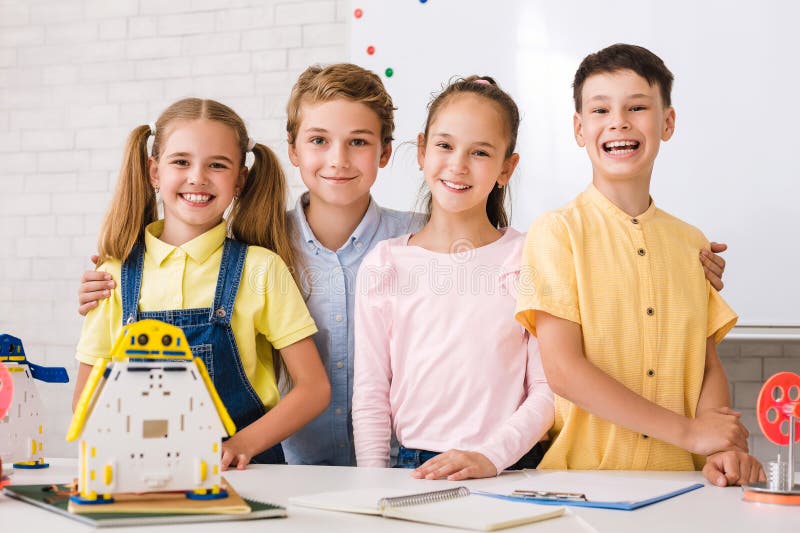 Smiling Students Working on Robotics Project in Classroom Stock Image ...