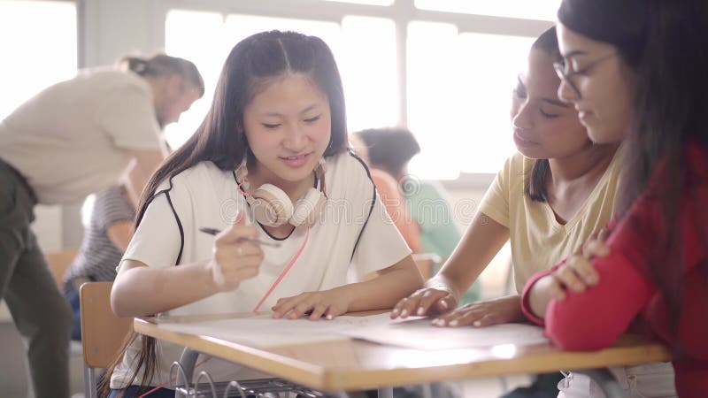 Smiling Students Working Together As a Team in Class. in the Background ...