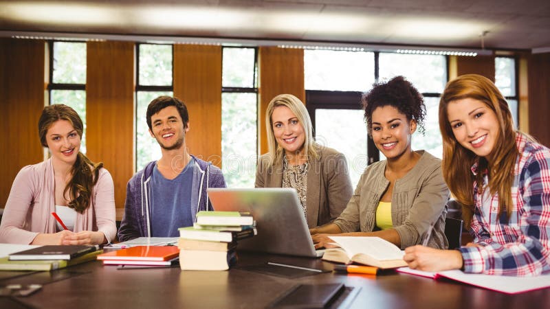 Smiling Students Working Together on an Assignment Stock Photo - Image ...