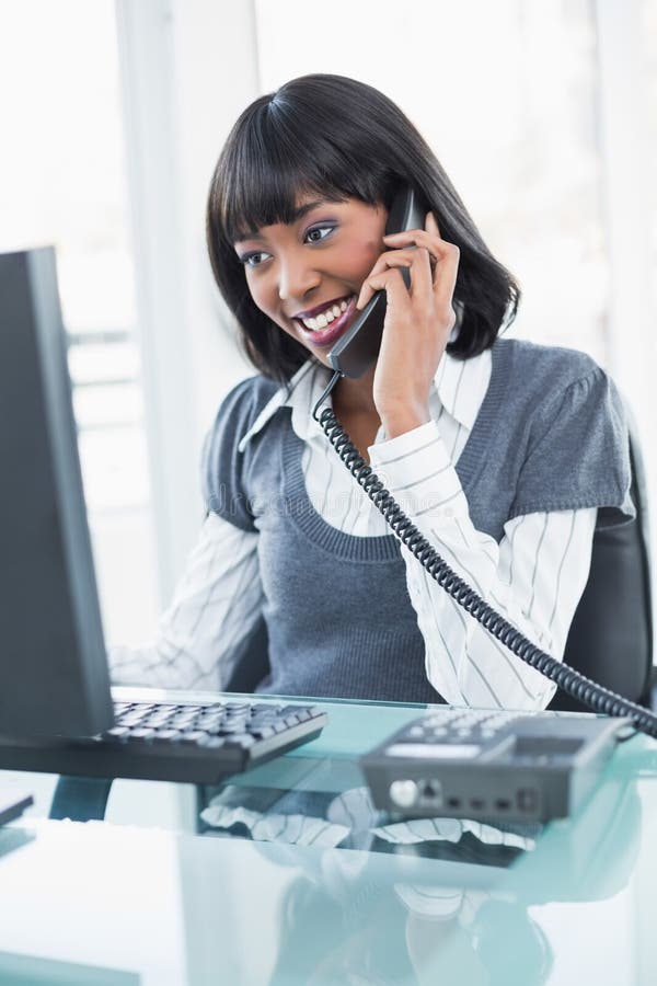 Smiling Stylish Businesswoman on the Phone while Working on Computer ...