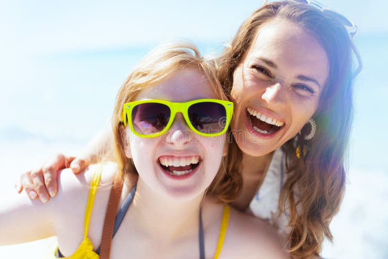 Smiling Stylish Mother and Child at Beach Having Fun Time Stock Photo ...