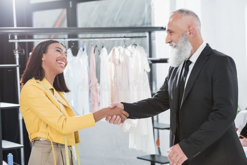 Smiling Stylist Greeting Grey Haired Customer Indoors Stock Image ...