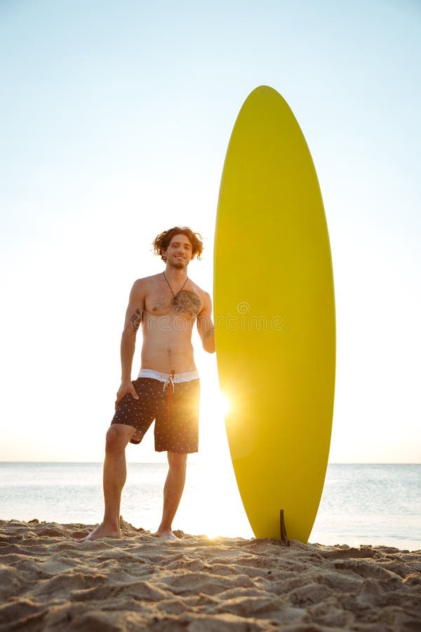 Smiling Surfer Holding Surf Board while Standing at the Beach Stock ...