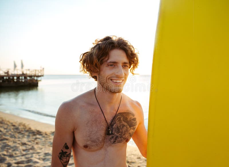 Smiling Surfer Holding Surf Board while Standing at the Beach Stock ...