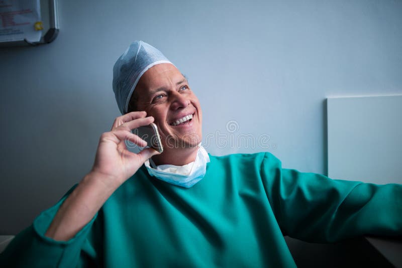Smiling Surgeon Talking on Mobile Phone Stock Image - Image of adult ...