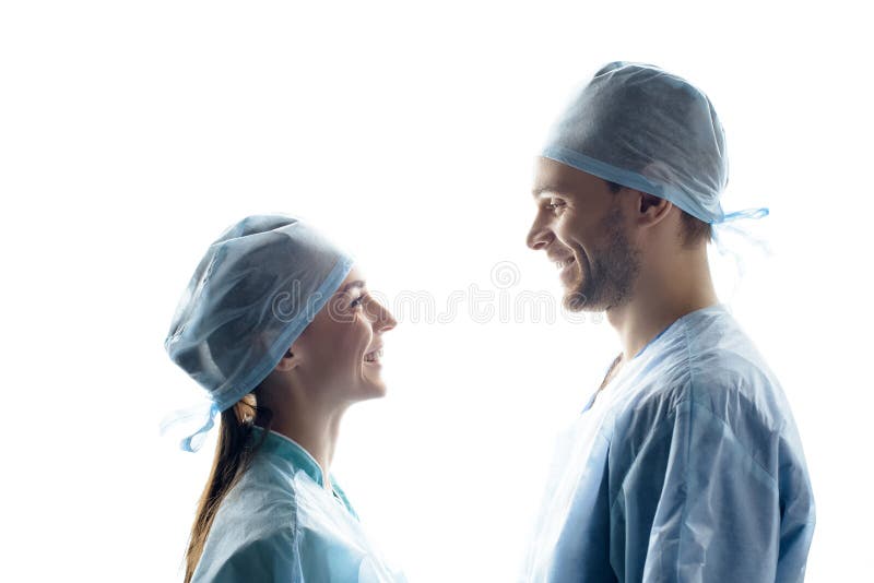 Smiling Surgeons in Medical Uniform Looking at Each Other on White ...