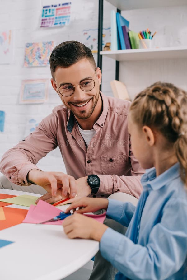 Smiling Teacher and Cute Preschooler Cutting Papers with Scissors Att ...