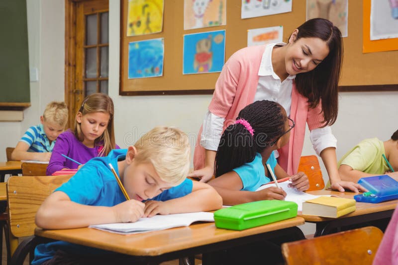 Smiling Teacher Helping a Student Stock Photo - Image of back ...