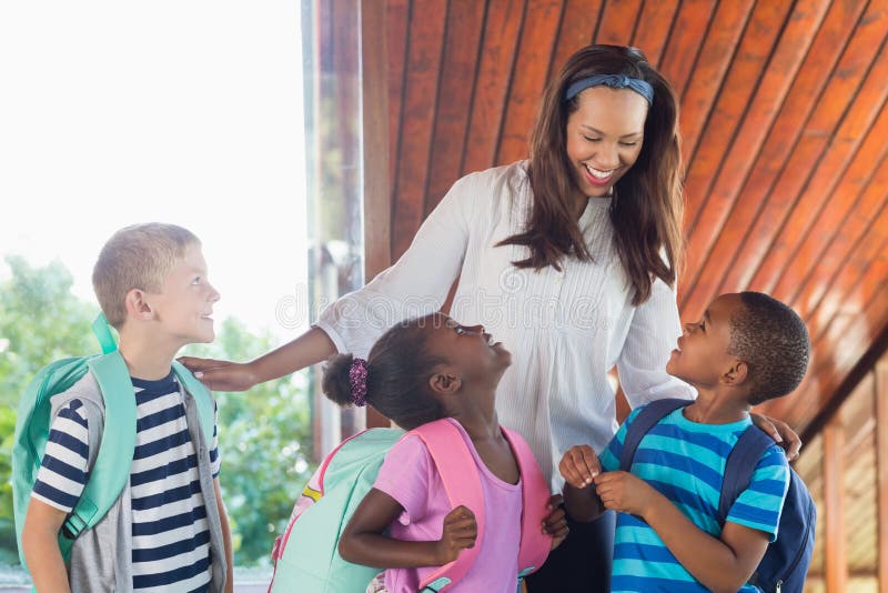 Smiling Teacher and Kids Talking with Each Other Stock Image - Image of ...