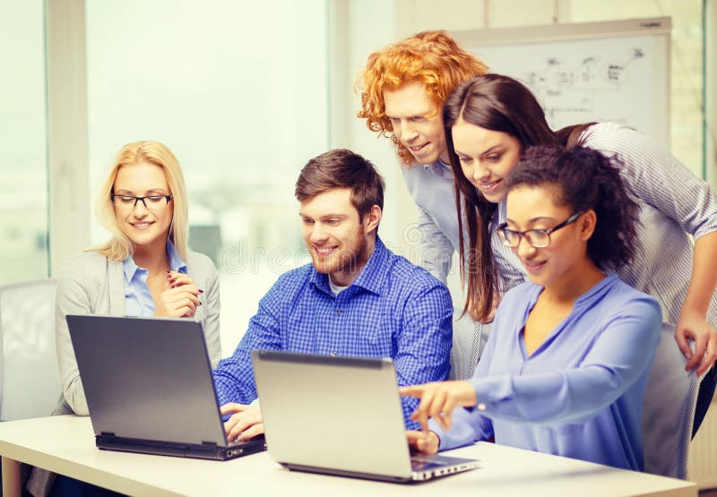 Smiling Team with Laptop Computers in Office Stock Photo - Image of ...