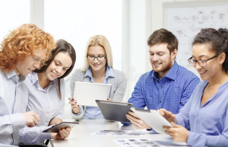 Smiling Team with Table Pc and Papers Working Stock Photo - Image of ...