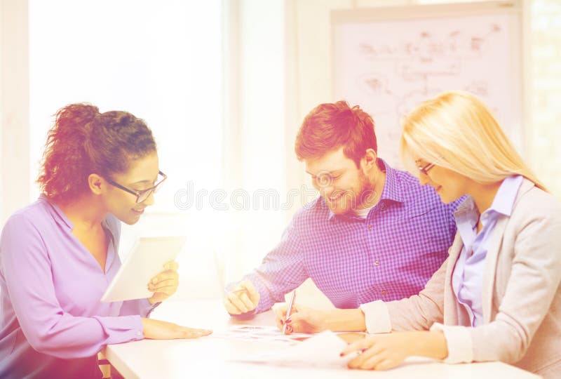 Smiling Team with Table Pc and Papers Working Stock Photo - Image of ...