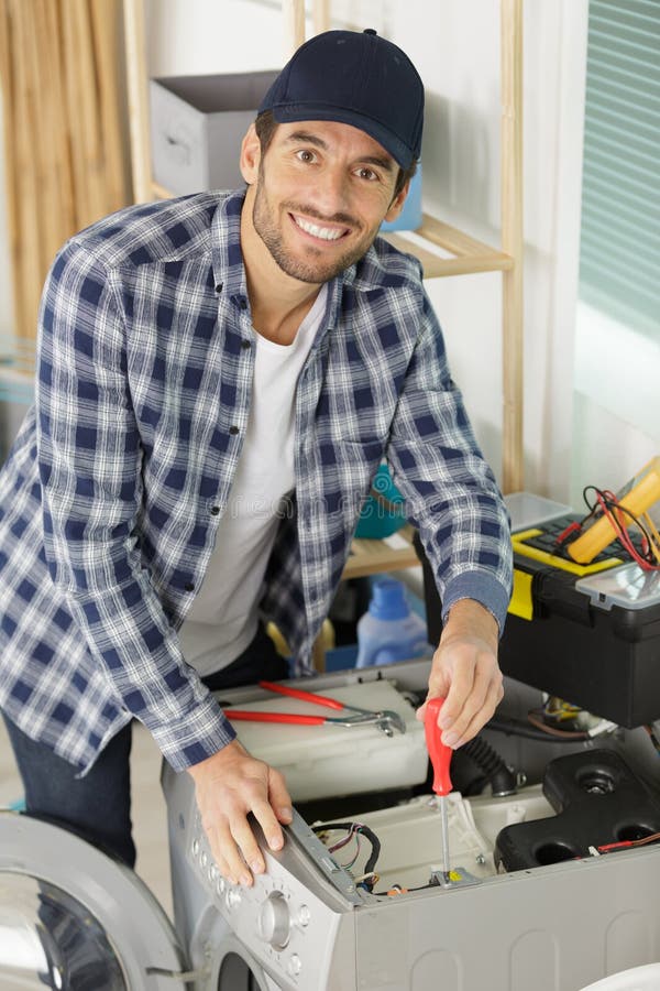 Smiling Technician Repairing Washing Machine Stock Image - Image of ...