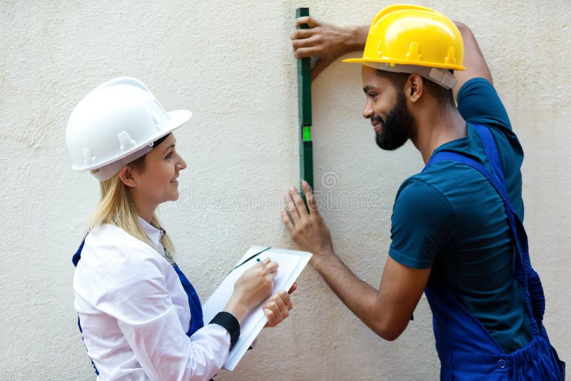 Smiling Technicians Smoothing the Wall Stock Photo - Image of engineer ...