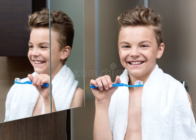 Teen boy brushing teeth stock photo. Image of handsome - 73147378