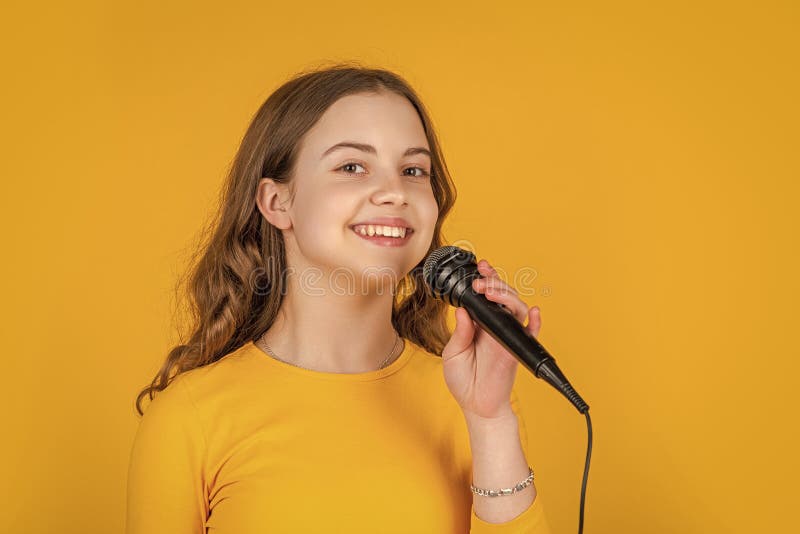 Smiling Teen Child with Microphone on Yellow Background Stock Image ...