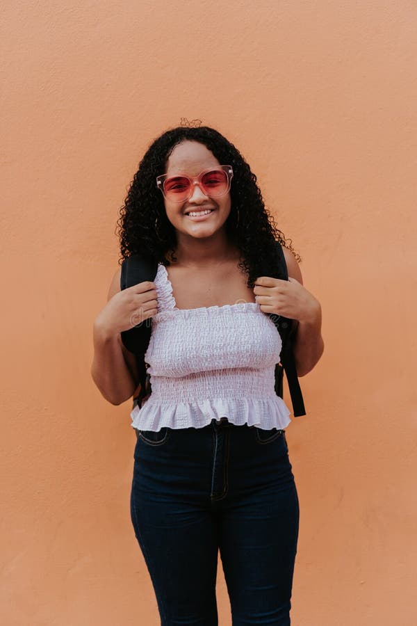 Smiling Teenager Carrying a Backpack while Standing in Front of the ...