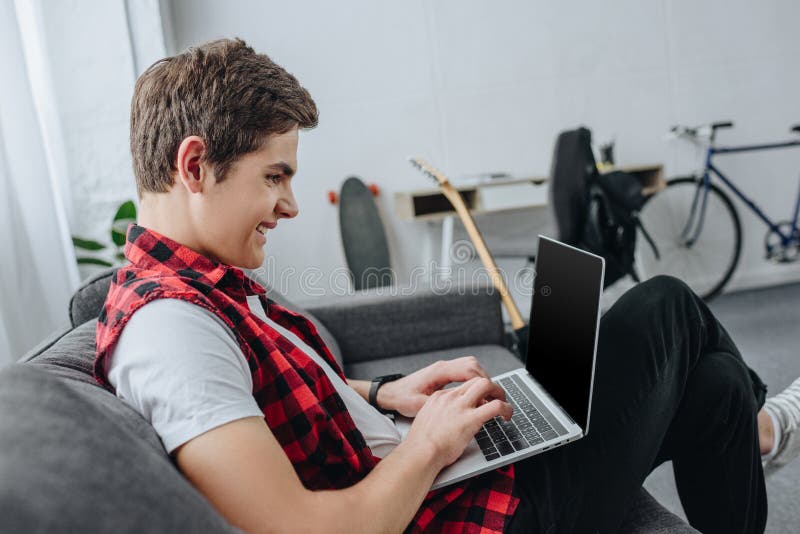 Smiling Teenager Typing on Laptop while Sitting Stock Image - Image of ...