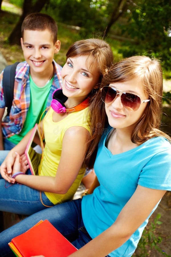 Two Teens Stand Back To Back - Vertical Stock Photo - Image of laughter ...