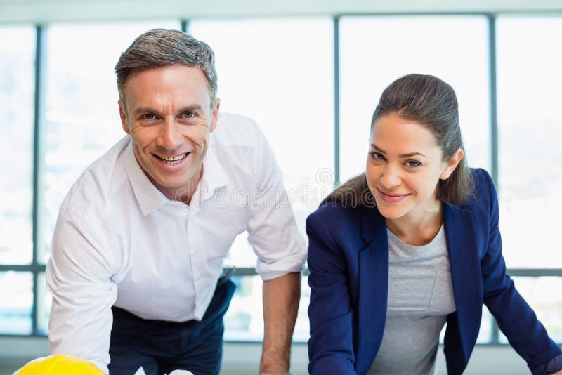 Smiling Three Architects Standing in Office with Blueprint and Laptop ...
