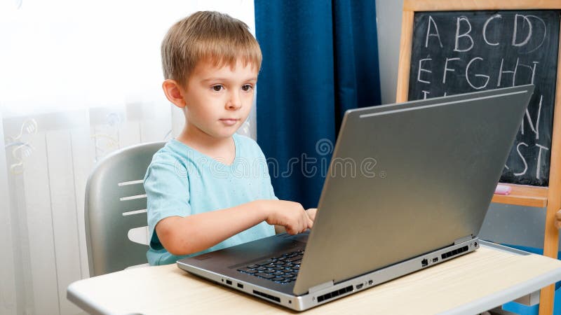 Smiling Toddler Boy Opens Laptop and Turn it on. Child Using Computers ...