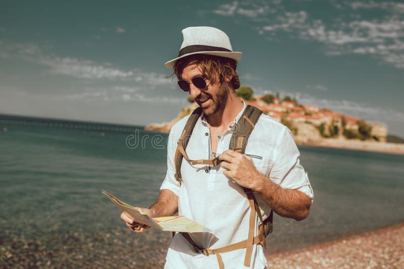 Tourist Man Standing with Map and Backpack Near the Sea Stock Image ...