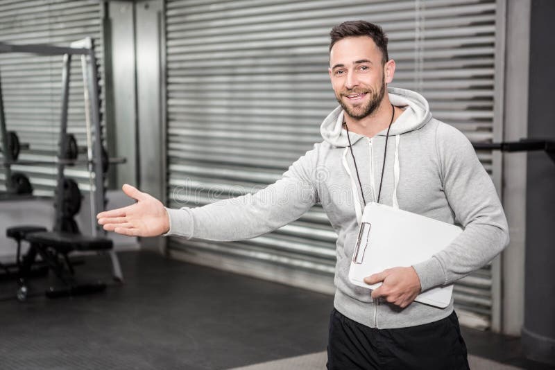 Smiling Trainer Showing Gym To Camera Stock Photo - Image of male ...