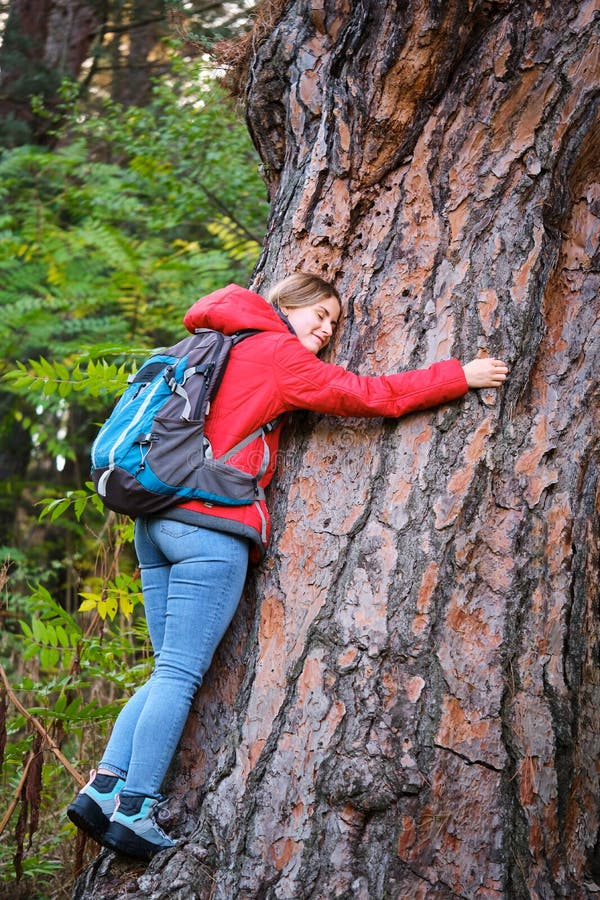 Smiling Trekker Hugging a Big Tree in the Forest. Stock Photo - Image ...