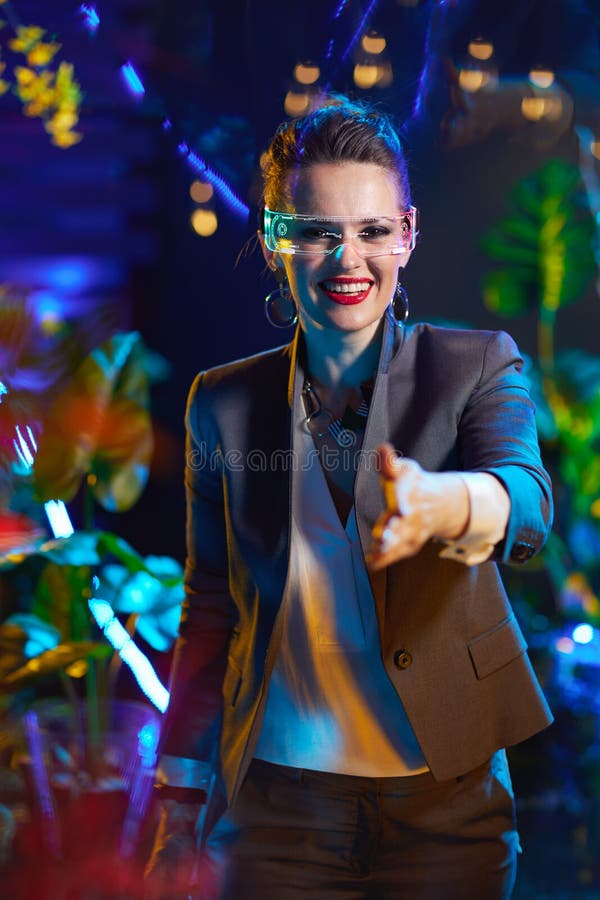 Smiling Female Giving Hand for Handshake in Virtual Reality Stock Photo ... Smiling Female Giving Hand for Handshake in Virtual Reality Stock Photo ...