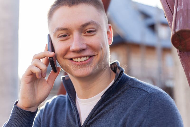 Smiling Trendy Guy Talking on the Phone Outdoor. Stock Image - Image of ...