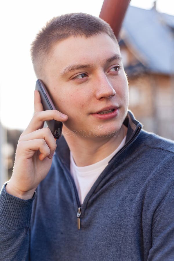 Smiling Trendy Guy Talking on the Phone Outdoor. Stock Image - Image of ...