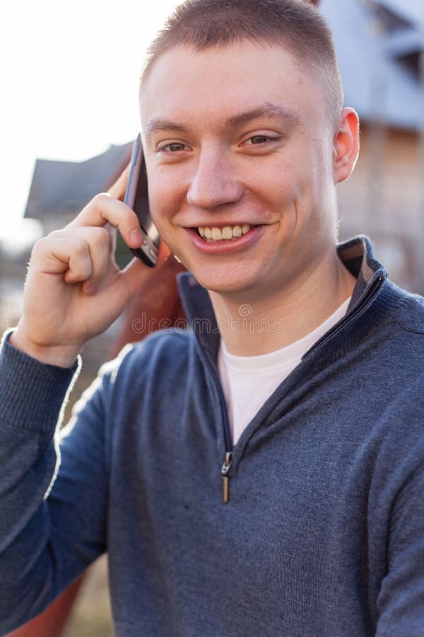 Smiling Trendy Guy Talking on the Phone Outdoor. Stock Image - Image of ...